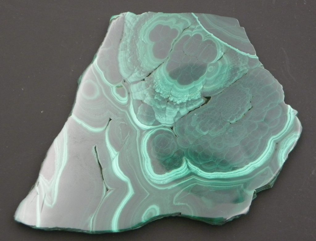 This polished malachite slice contains beautiful orbs and swirls.